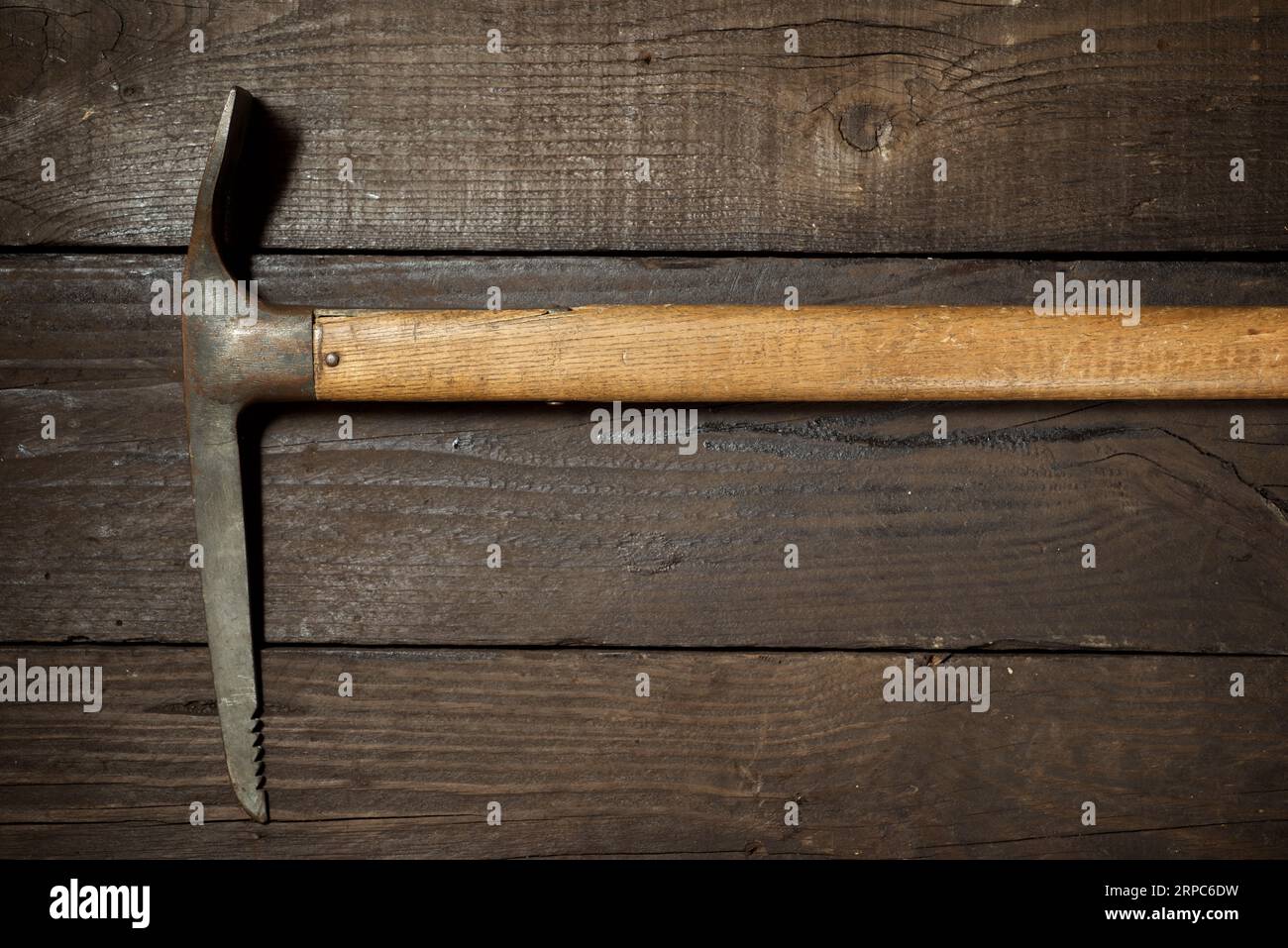 Old ice-axe on a wood table Stock Photo - Alamy