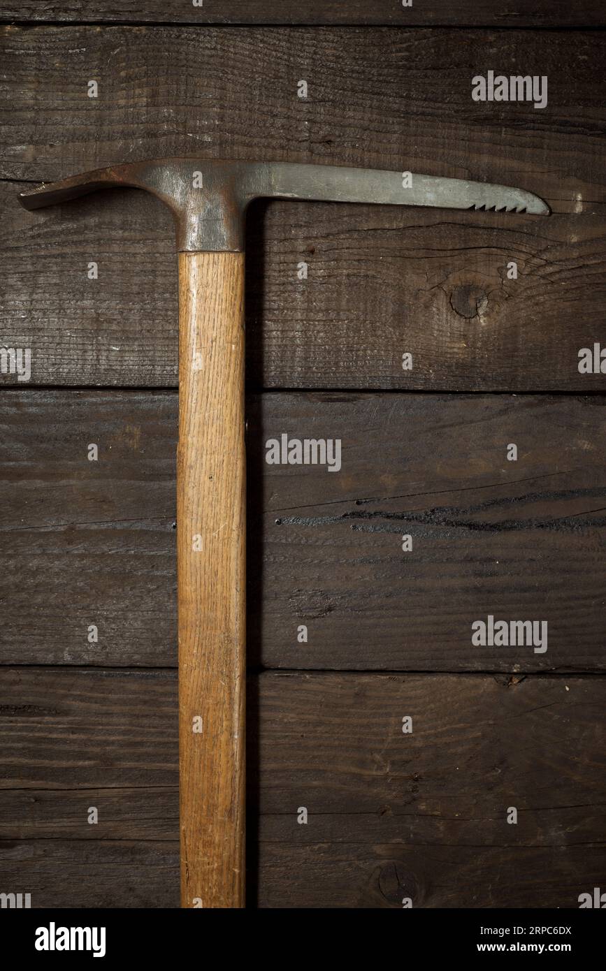 Old ice-axe on a wood table Stock Photo - Alamy
