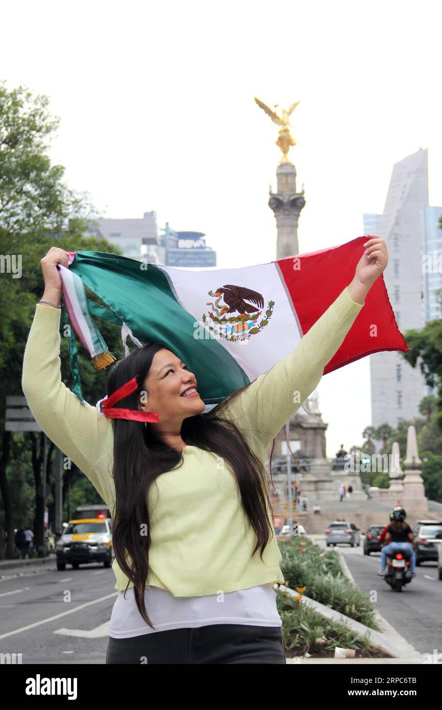 Latin adult woman shows the flag of mexico proud of the culture and ...