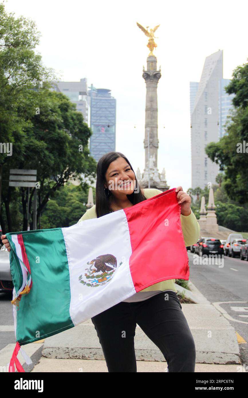 Latin adult woman shows the flag of mexico proud of the culture and ...
