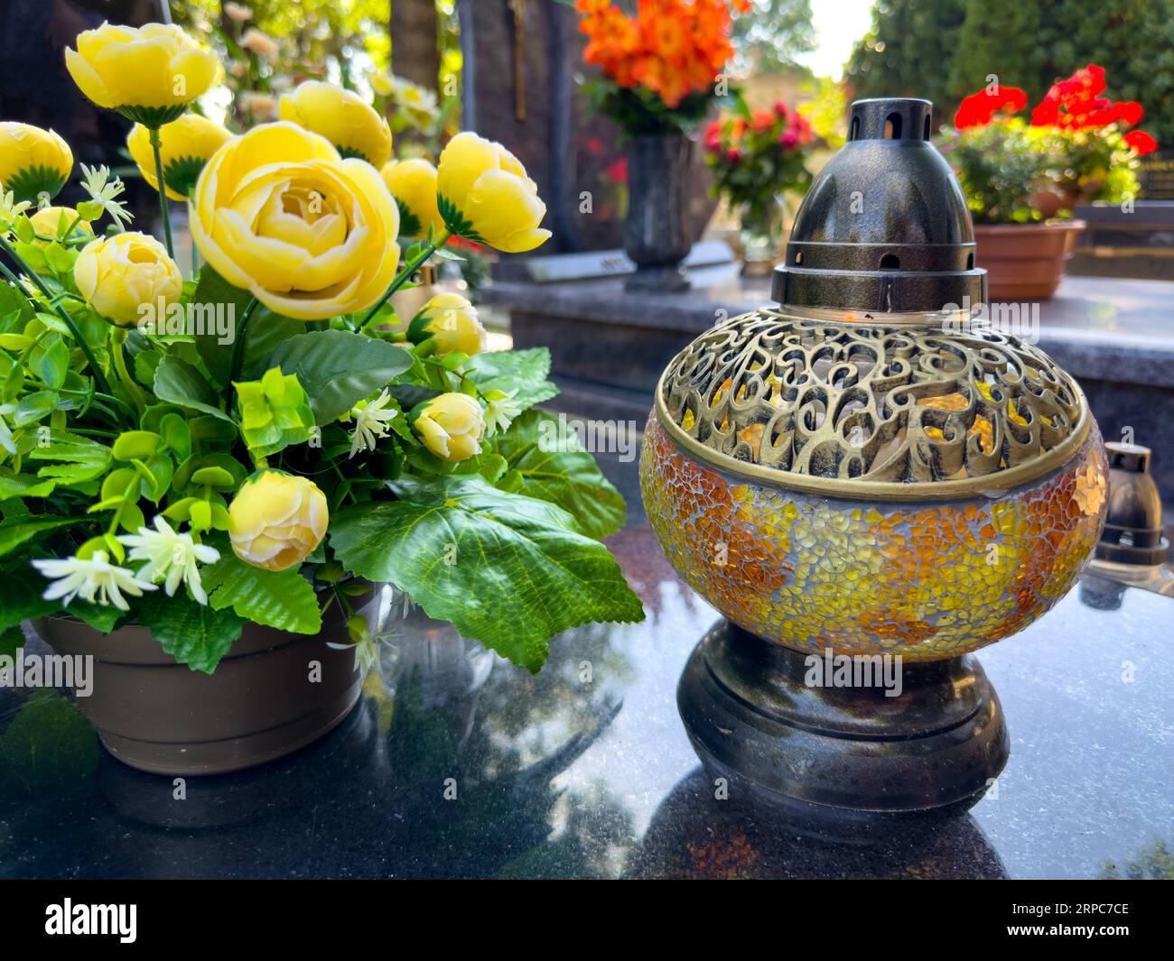 Grave candle on a black grave. Gravyard. All Souls' Day. All Saints day ...