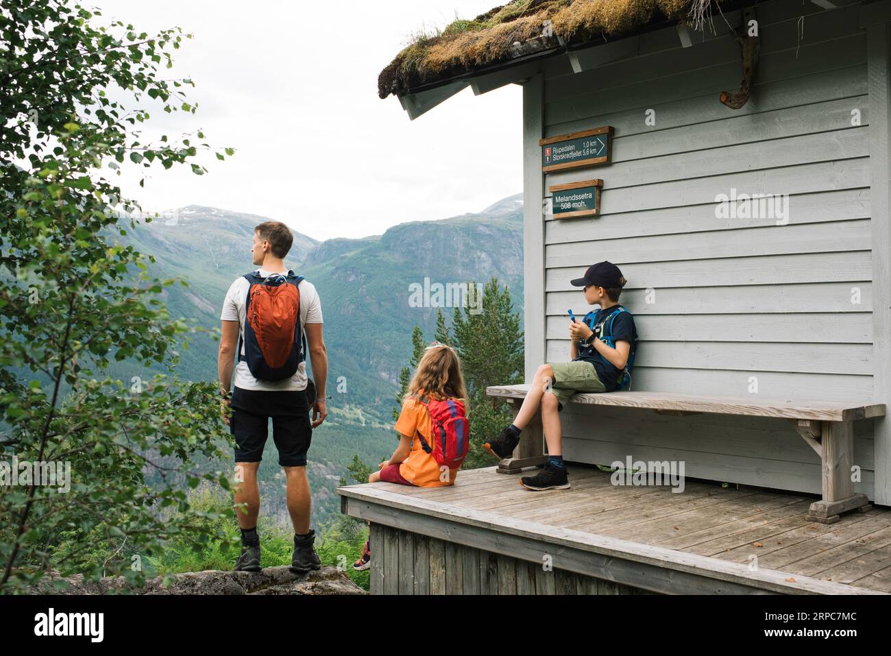 family taking a break whilst hiking up a mountain in Norway Stock Photo ...
