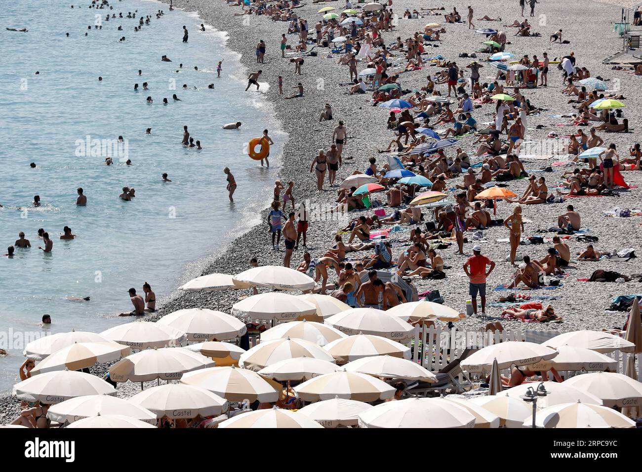 (190629) -- NICE, June 29, 2019 -- People enjoy the sun on the beach in ...