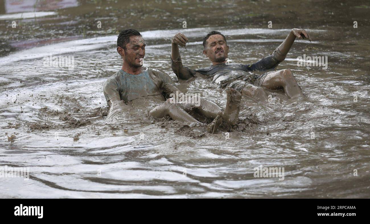 (190629) -- LALITPUR, June 29, 2019 -- Nepalese people splash muddy ...