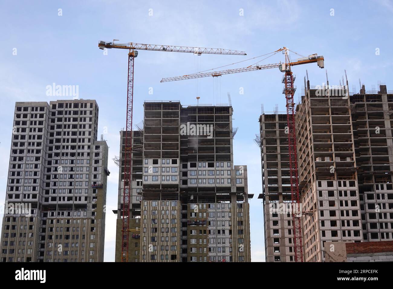 Tower cranes being constructed high modern residential buildings in ...