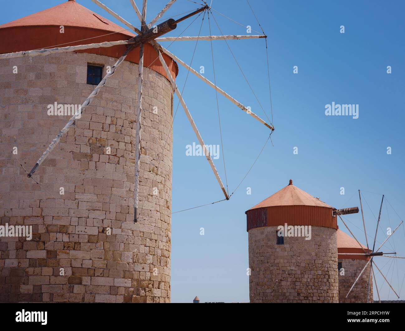 Windmills in the Mandraki port of Rhodes, Greece. Old defensive stands ...