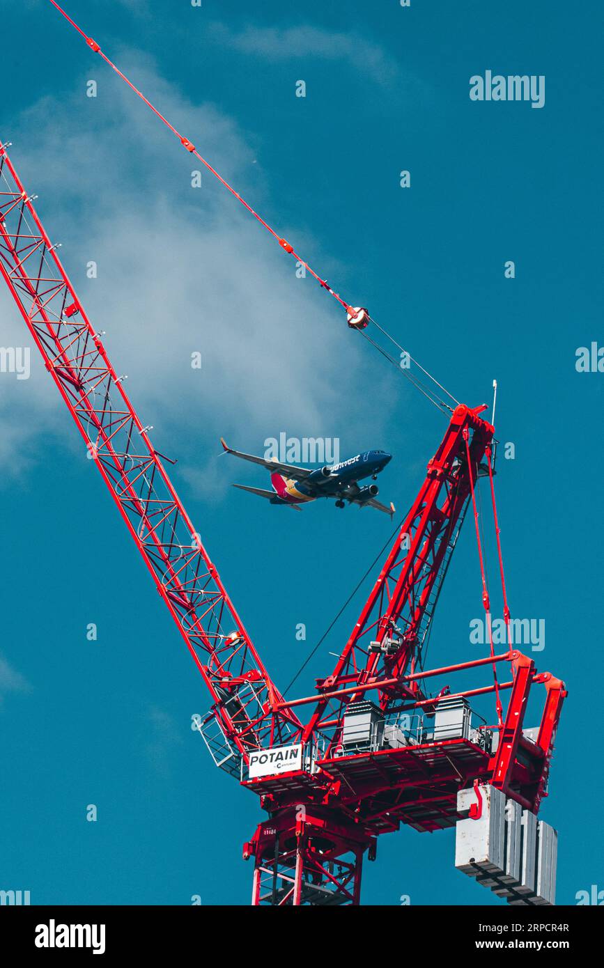 Southwest Airplane Flying Through Sky with a Red Crane in the ...
