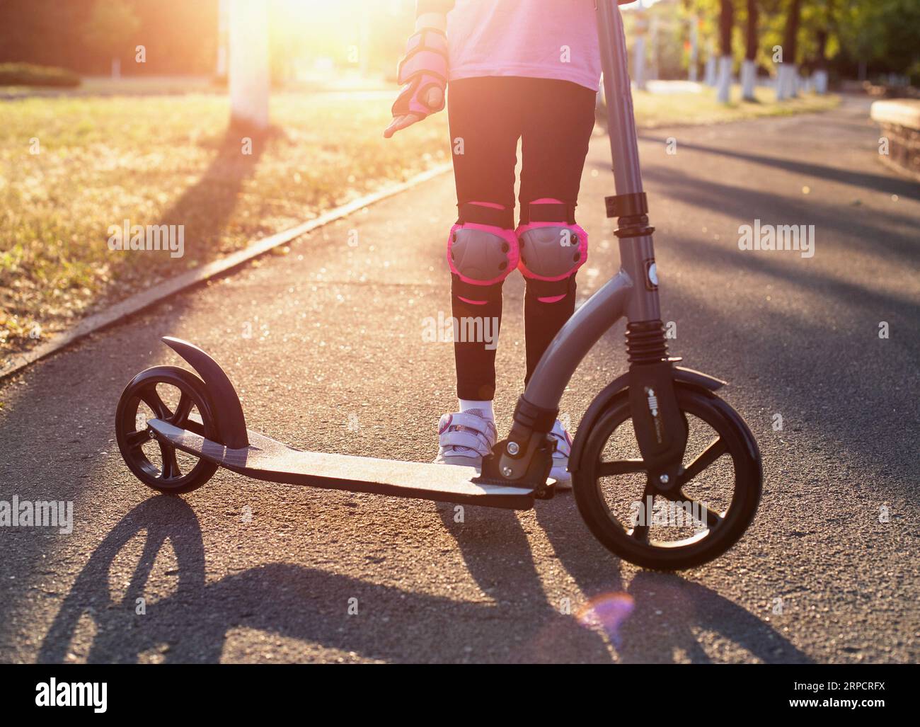 Legs of a girl in protective equipment against injuries on the ...