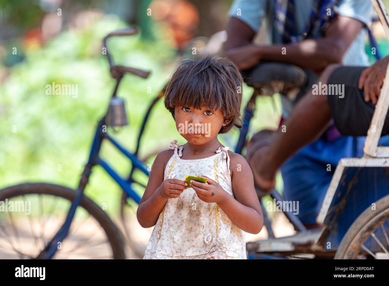 MIANDRIVAZO, MADAGASCAR - NOVEMBER 2, 2022: A young girl walks along a ...