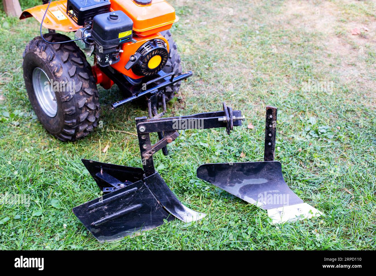 Plow and hiller complete with a walk-behind tractor for agricultural ...