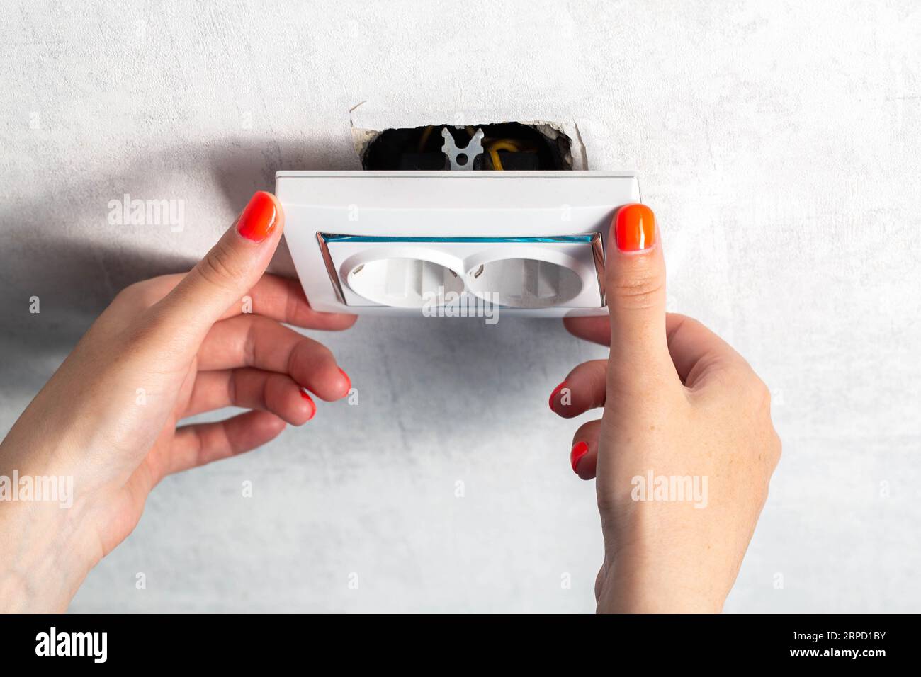 The girl is trying to insert a torn out socket from the socket due to ...