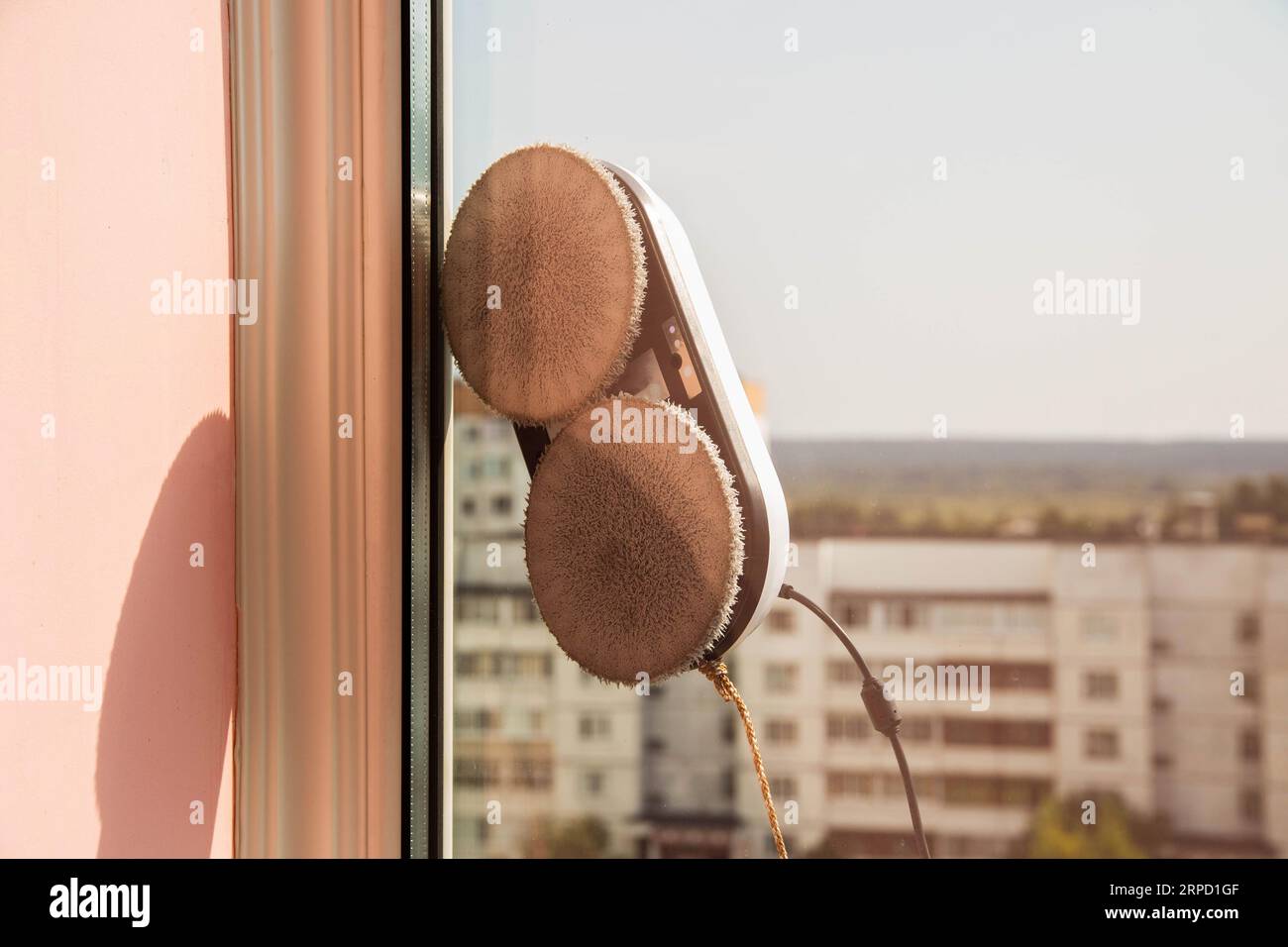 A modern vacuum robot window cleaner washes glass from dirt and stains ...