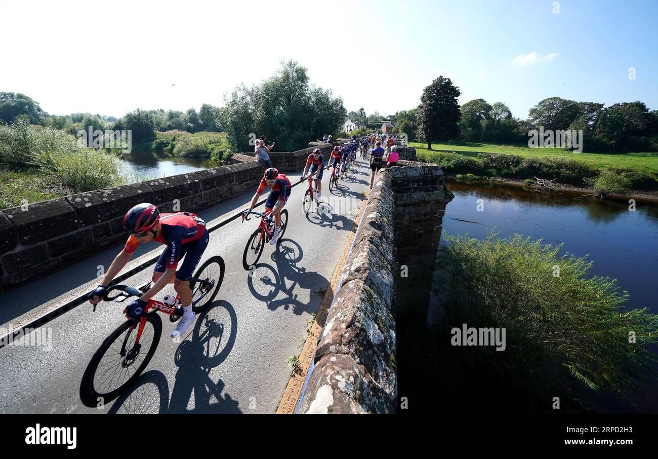 The peloton goes over the Farndon Bridge during stage two of the 2023 ...