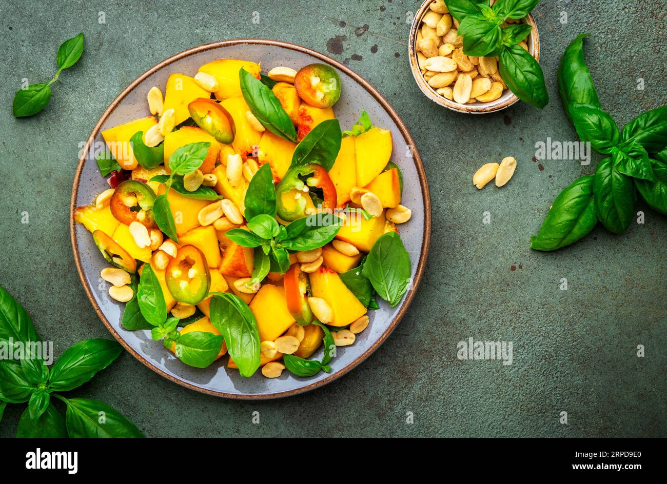 Exotic gourmet salad with juicy sweet peach, hot jalapeno peppers ...