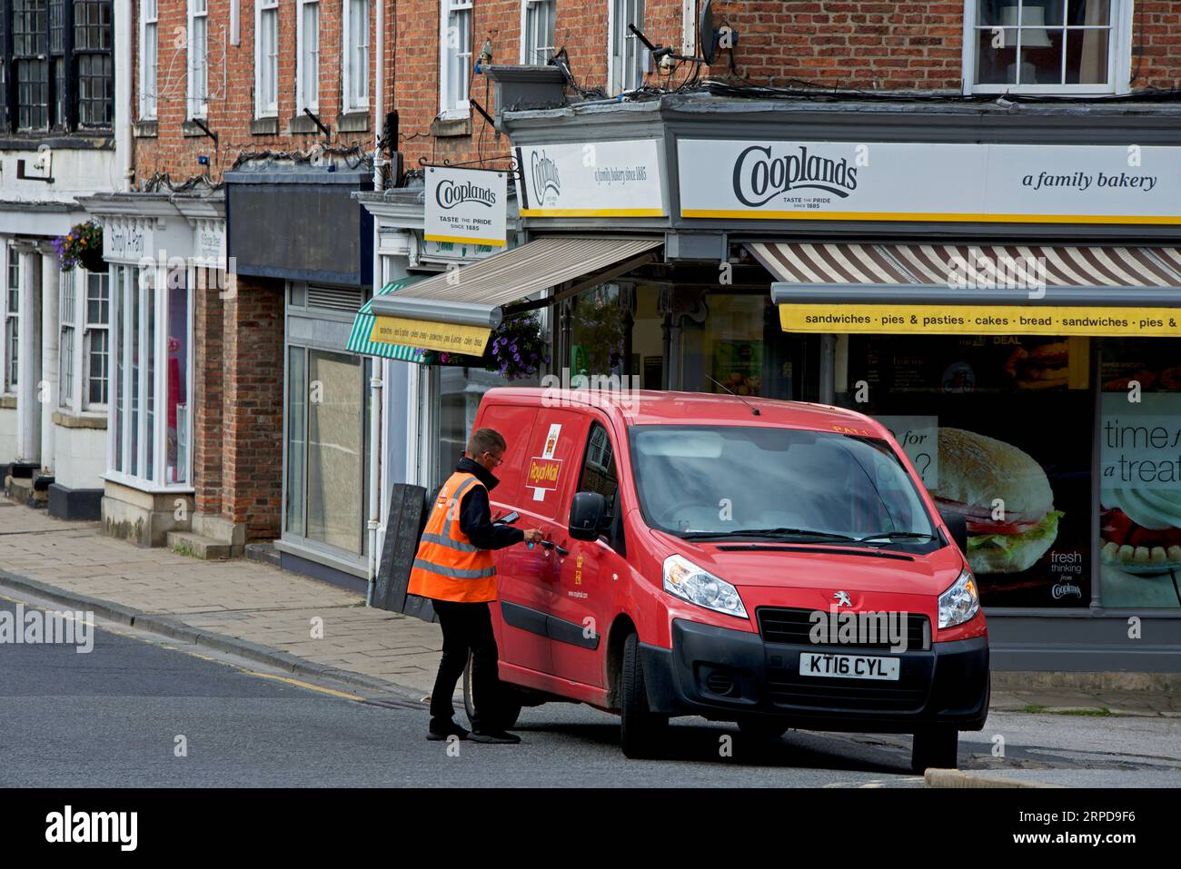 Postman and Royal Mail van in Tadcaster, North Yorkshire, England UK ...