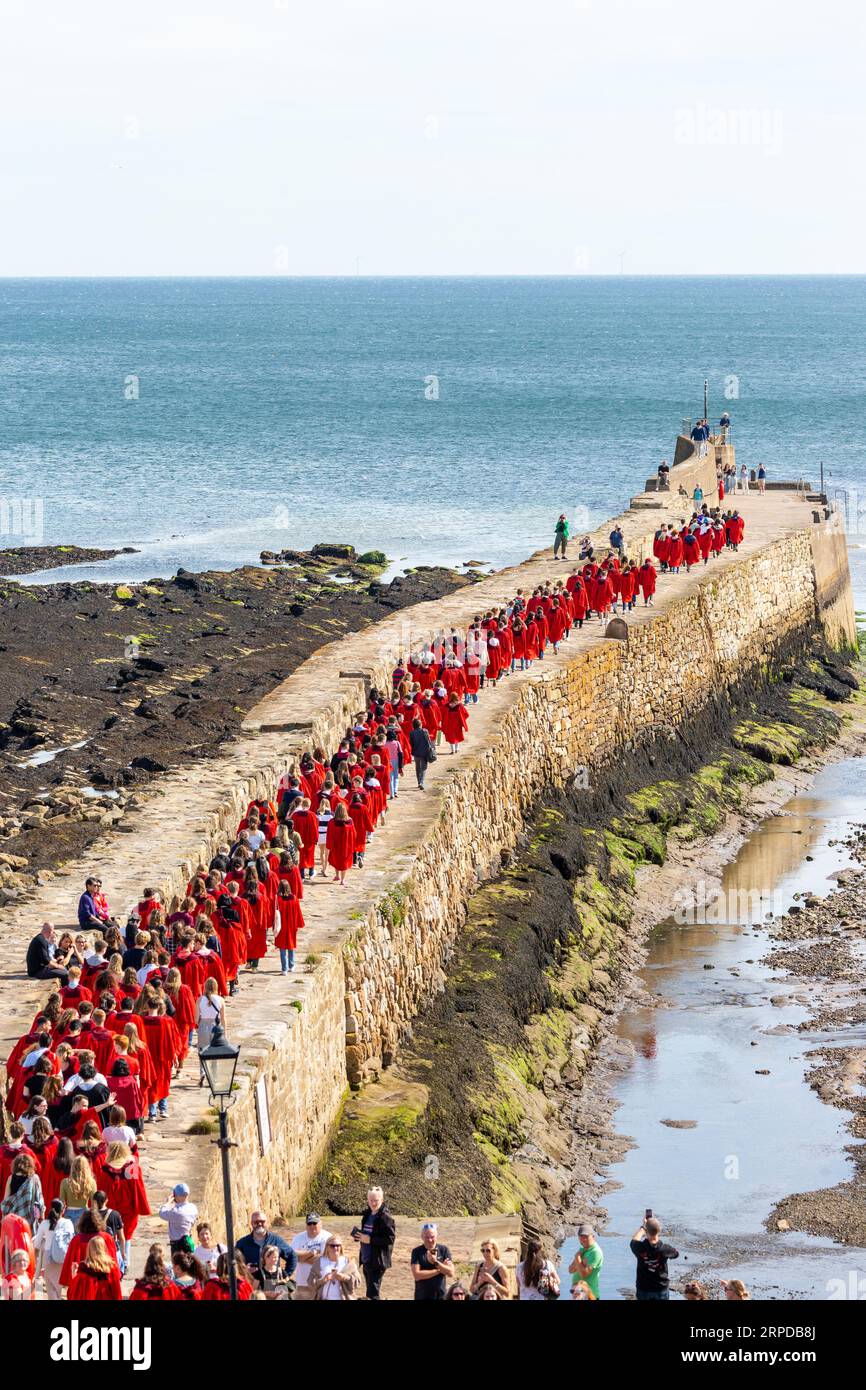 New students at the University of St Andrews wearing red robes take ...
