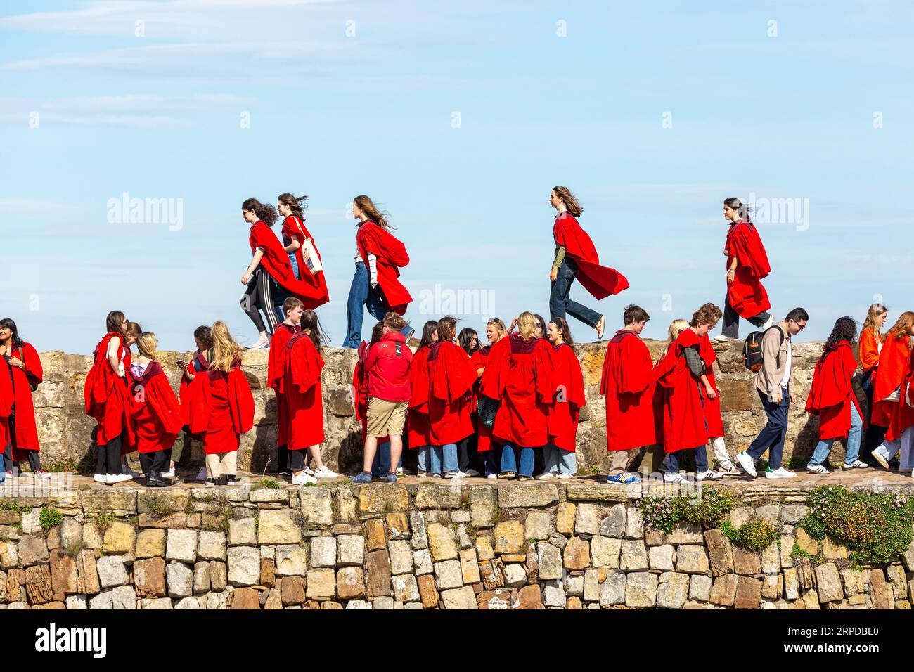 New students at the University of St Andrews wearing red robes take ...