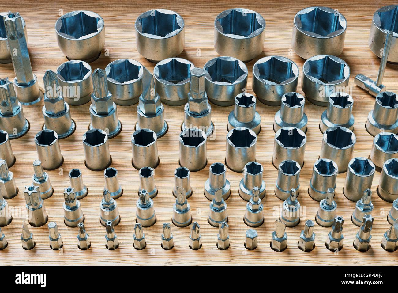 Collection of various types of bits. Removable screwdriver. Wooden ...