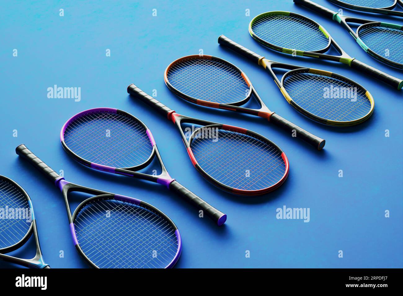 Professional tennis racquets in various colors. Blue background. Game ...