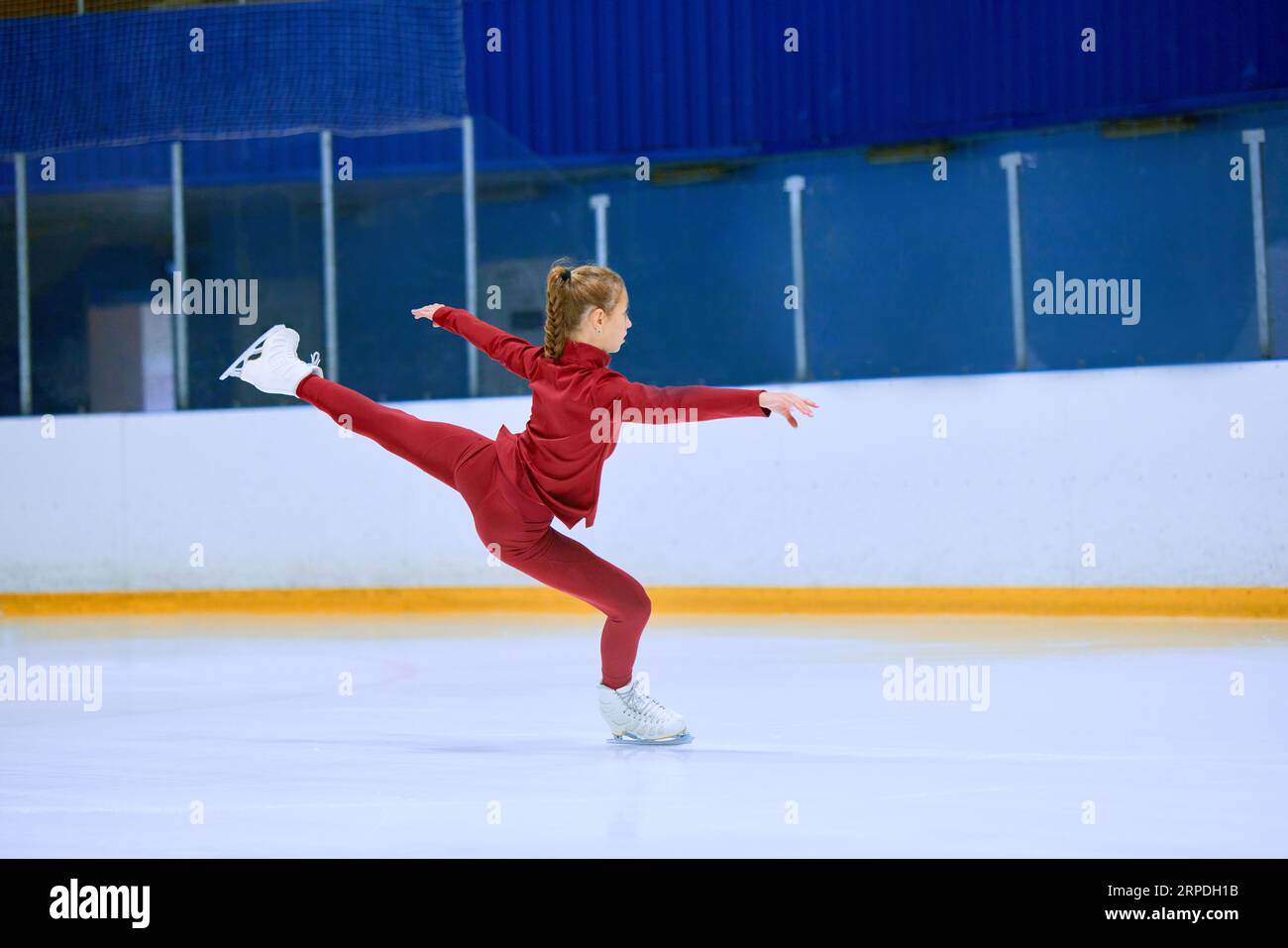 Teen girl, figure skating athlete in motion during training session on ...