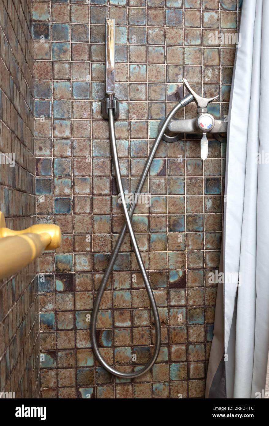 Old brown shower with a curtain, still in use Stock Photo - Alamy