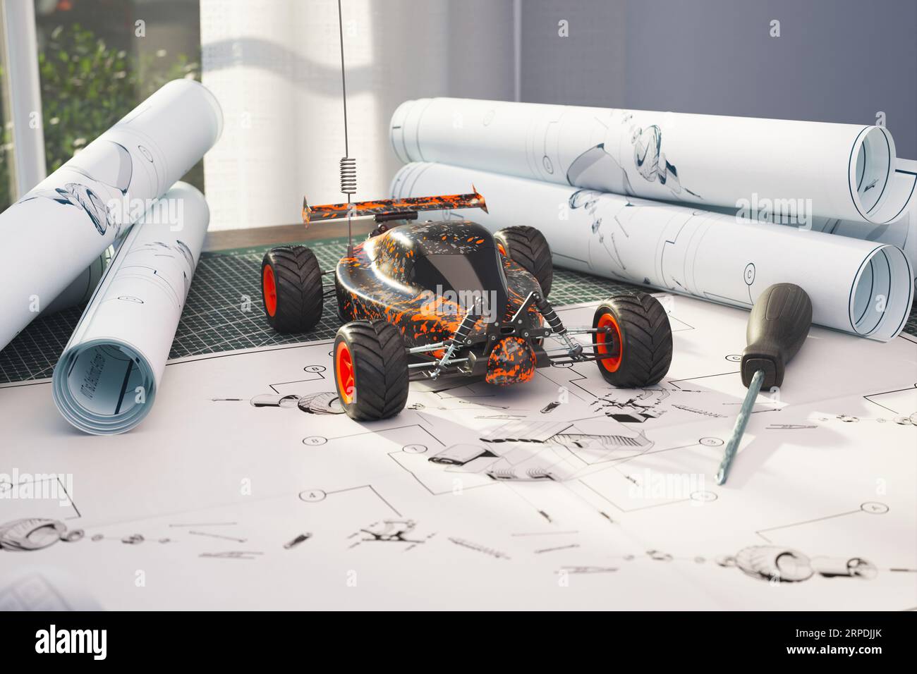 New RC-car standing on blueprints on a desk. Sunlight pouring through a ...