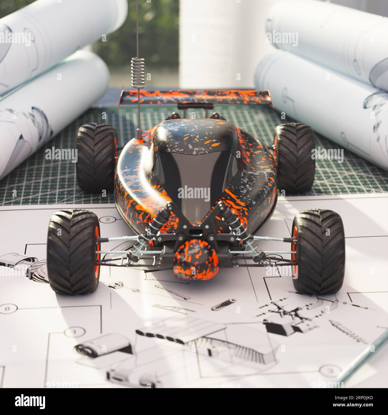 New RC-car standing on blueprints on a desk. Sunlight pouring through a ...