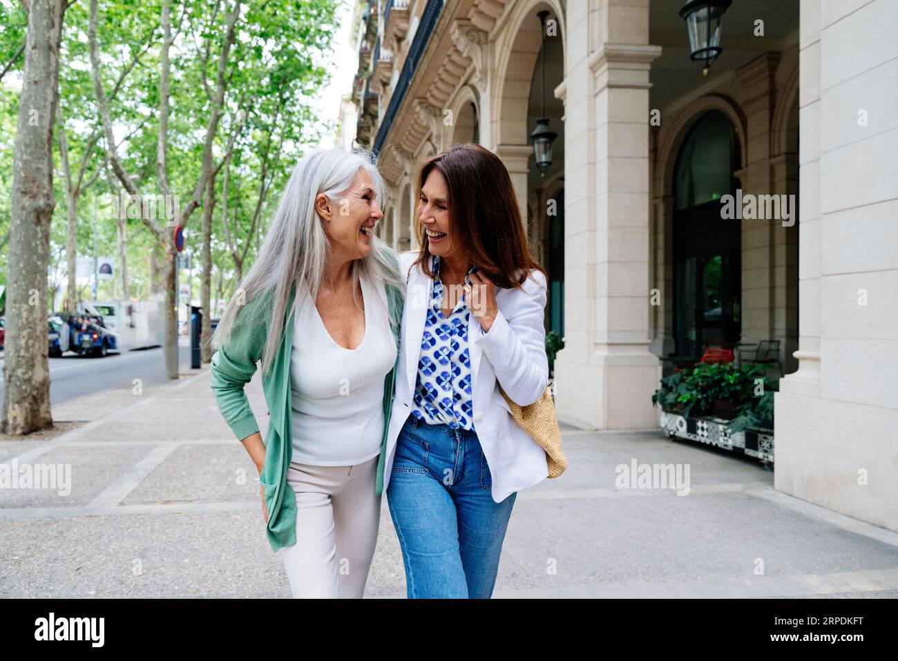 Beautiful senior women bonding outdoors in the city - Attractive ...