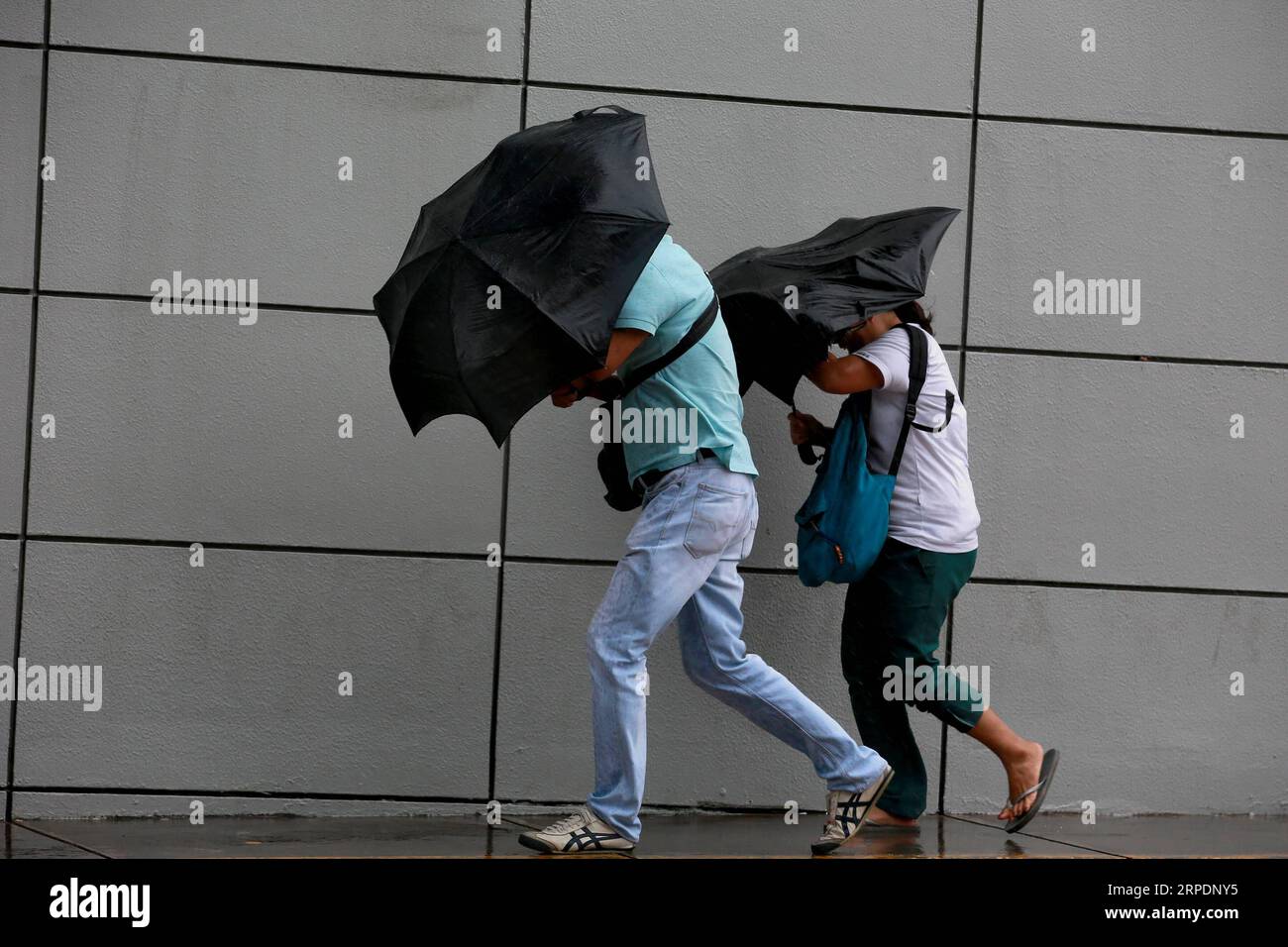 (190809) -- QUEZON CITY, Aug. 9, 2019 -- People use their umbrellas to ...