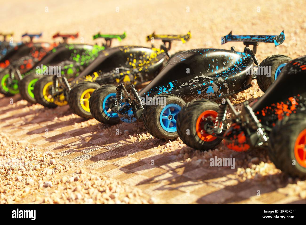 Multiple colourful remote-controlled buggy cars on start line in the ...
