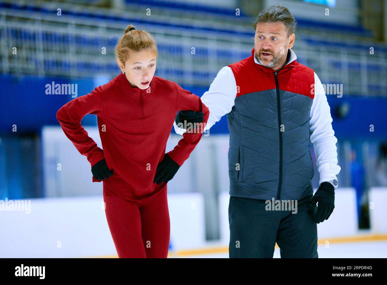 Professional skater, man training girl, learning figure skating ...
