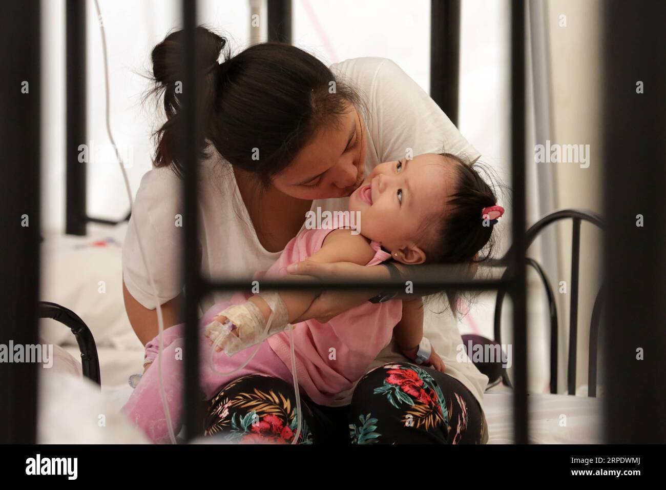 (190813) -- CAVITE PROVINCE, Aug. 13, 2019 -- A mother plays with her sick child as they rest ...