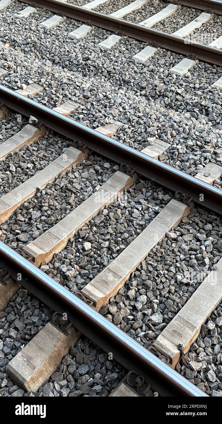 Train tracks. City train line built on pebbles Stock Photo - Alamy