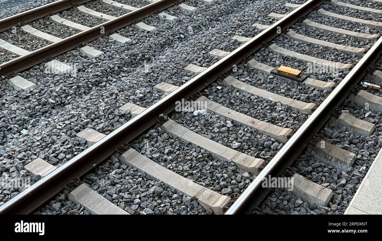 Train tracks. City train line built on pebbles Stock Photo - Alamy