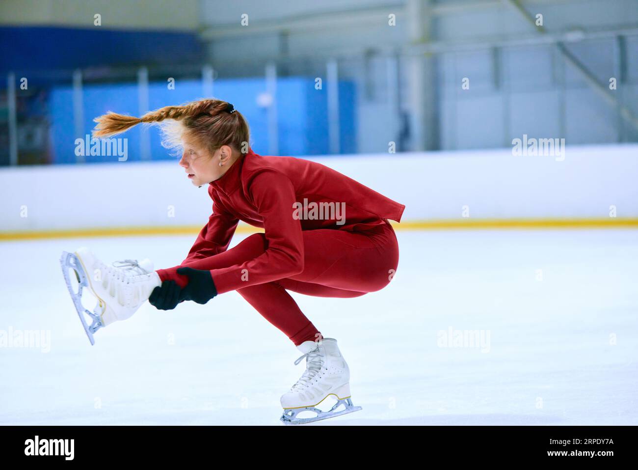 Spinning techniques and exercises. Girl, figure skating athlete in red ...