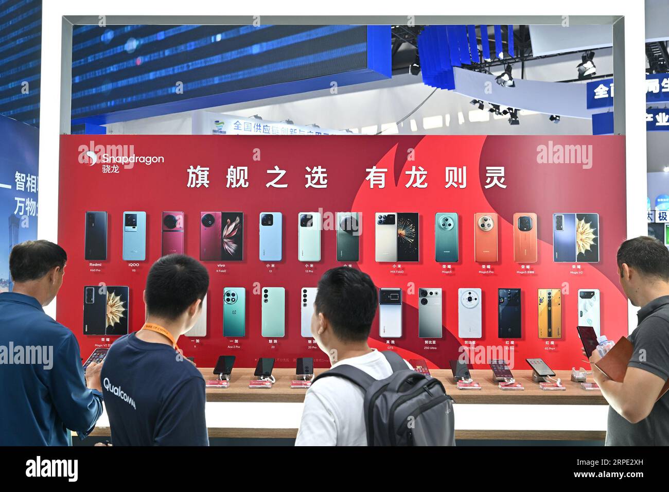 Beijing, China. 4th Sep, 2023. Visitors look at mobile phones equipped ...