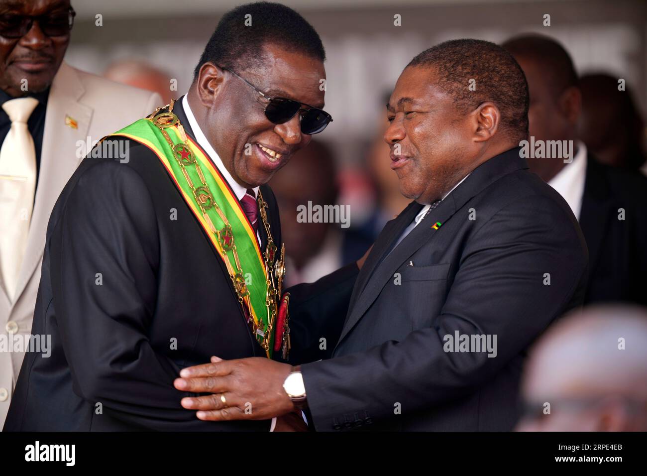 Zimbabwe President Emmerson Mnangagwa, left, greets Mozambique ...