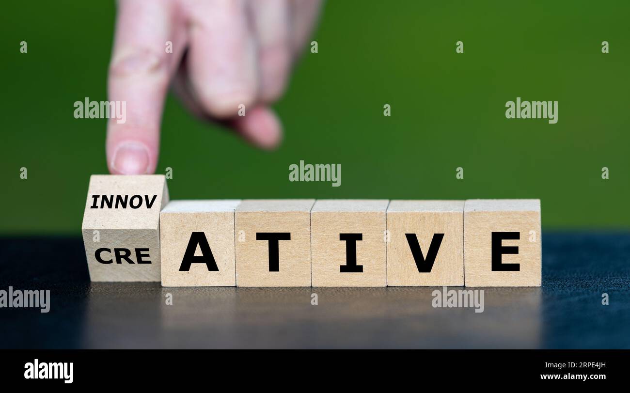 Wooden cubes form the words innovative and creative. Symbol for being ...