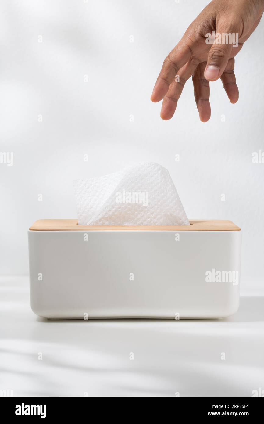 The man is grabbing a tissue paper from a white box Stock Photo - Alamy