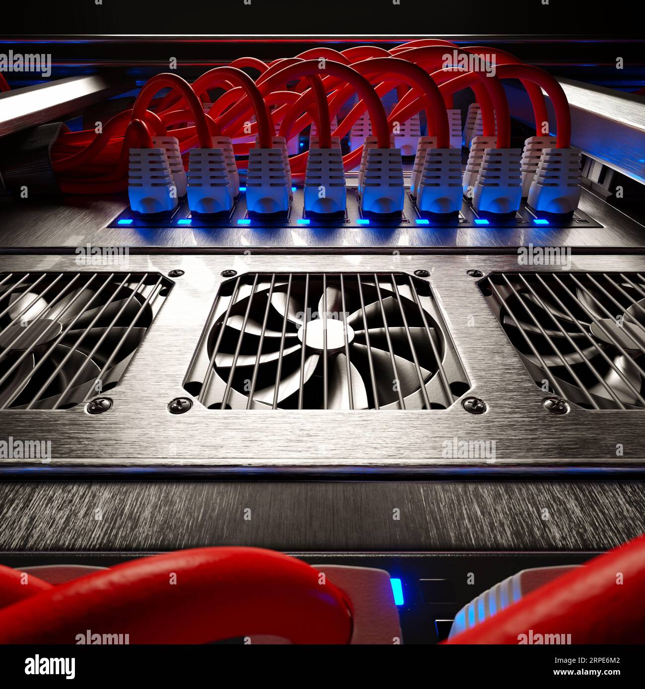 Many red cables and spinning fans in a server cabinet lit by a ...