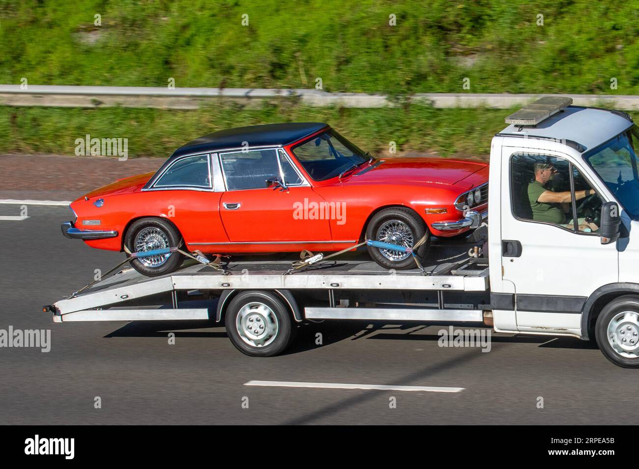 Vintage Triumph Stage car on Iveco van trailer; travelling at speed on ...