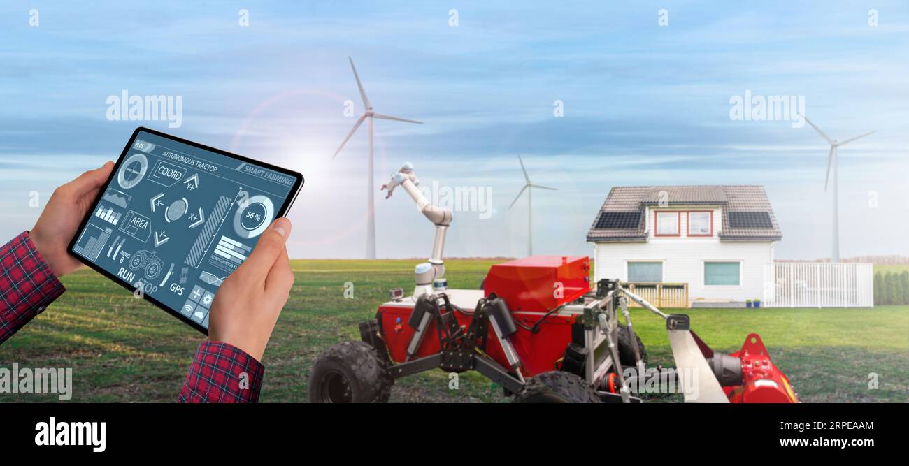 Man farmer holds the computer in his hands and controls of autonomous ...