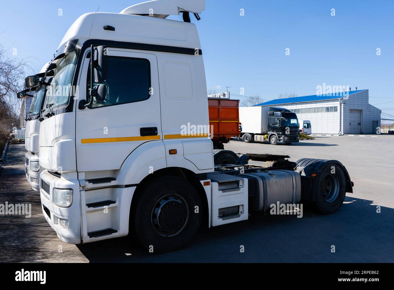 Semi truck fleet at the logistics center Stock Photo - Alamy