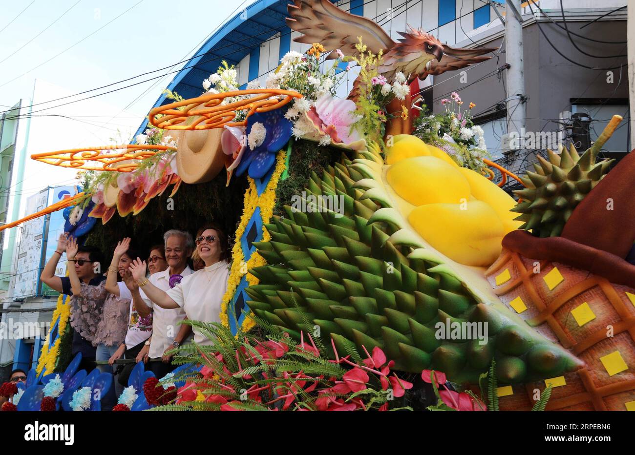 (190824) -- DAVAO, Aug. 24, 2019 -- Revelers wave atop a float during ...