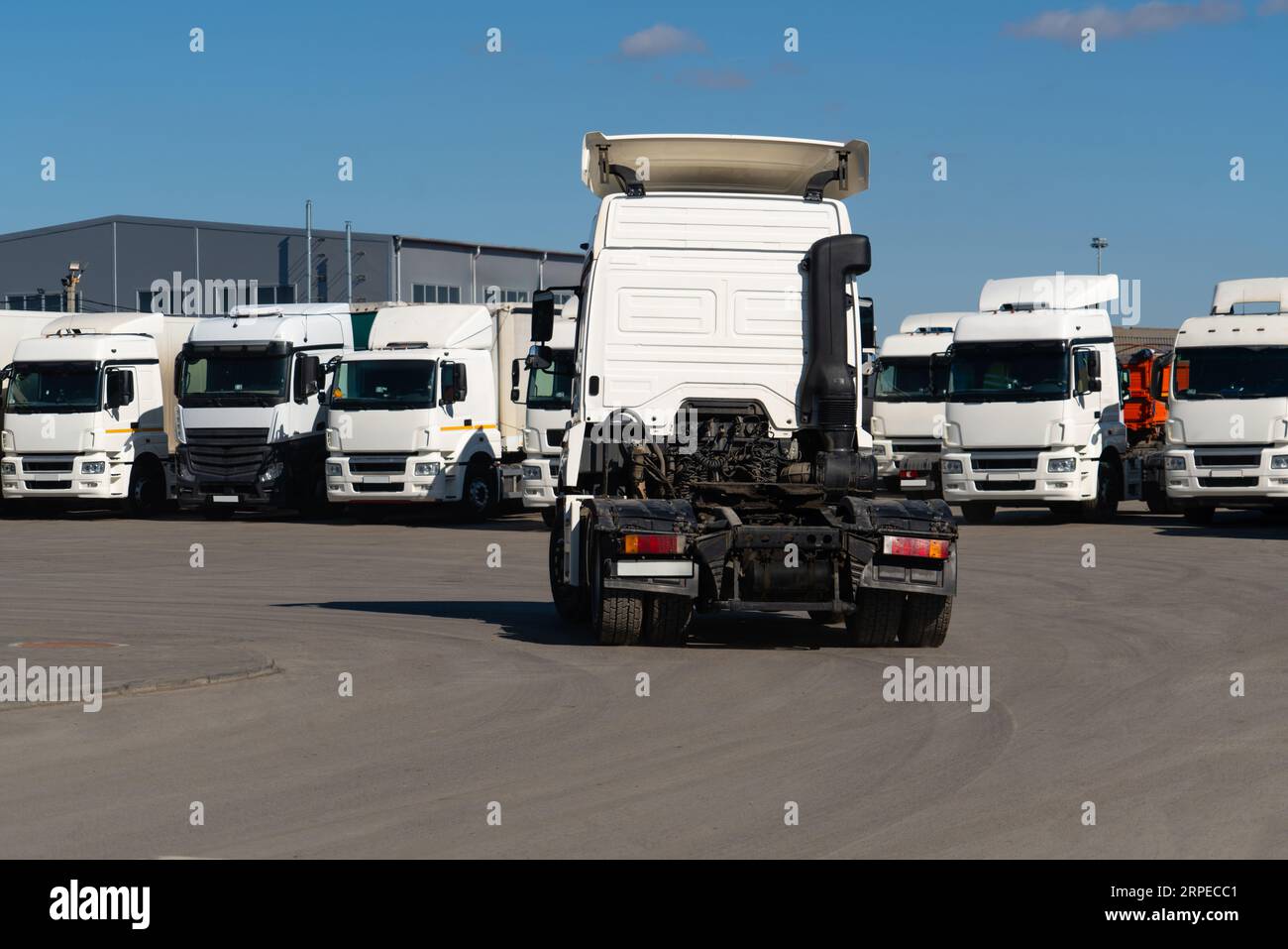 Semi truck fleet at the logistics center Stock Photo - Alamy