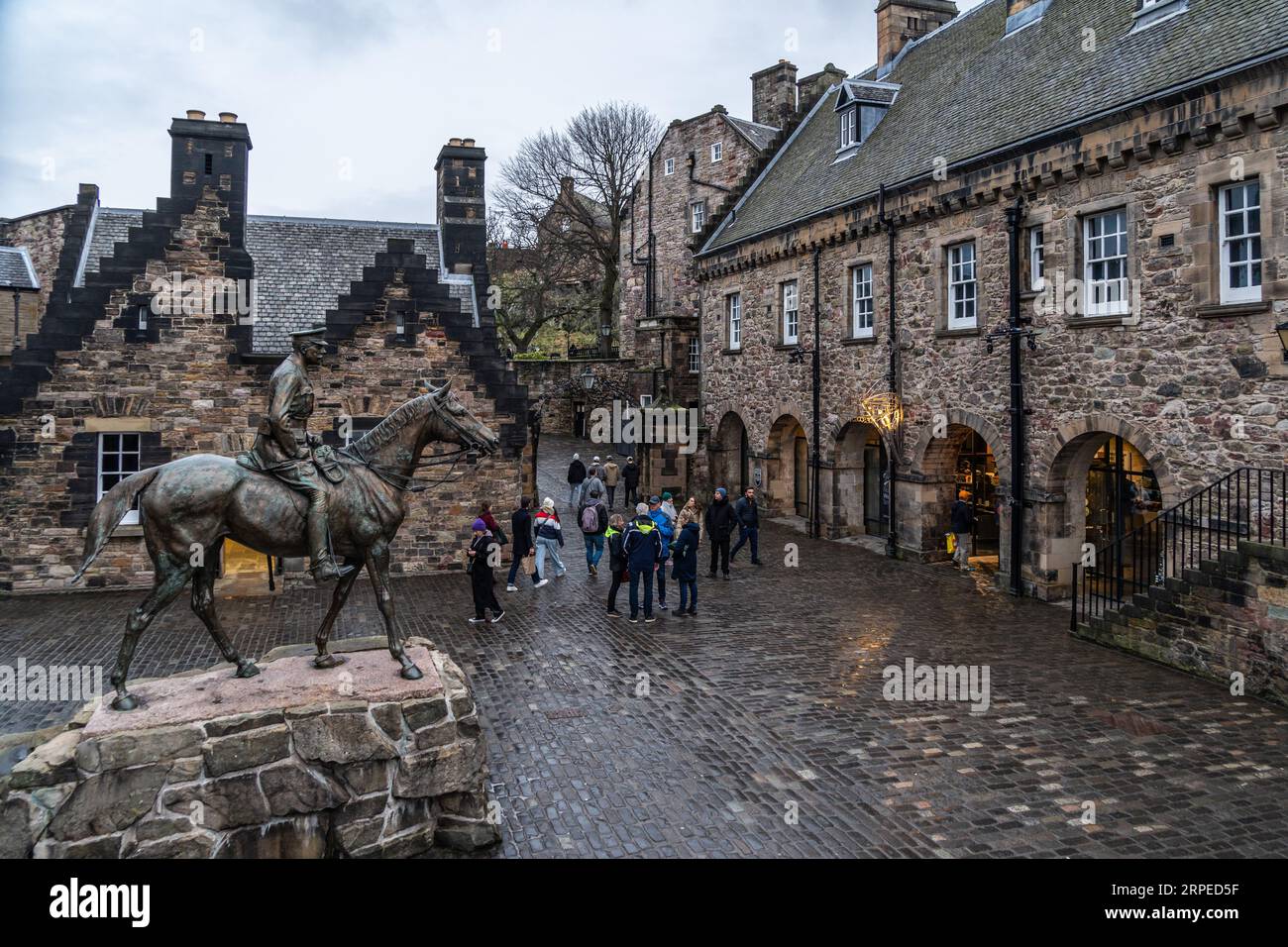 A scenic courtyard with a cobblestone walkway, featuring a horse statue ...