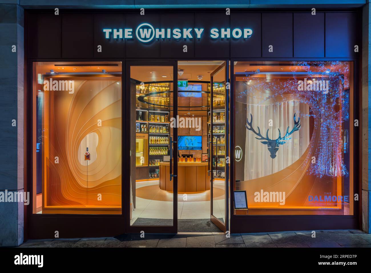 A modern whisky store with illuminated signage, inviting customers to ...