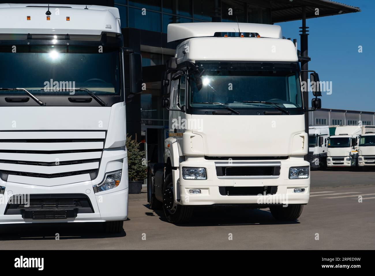 Semi truck fleet at the logistics center Stock Photo - Alamy