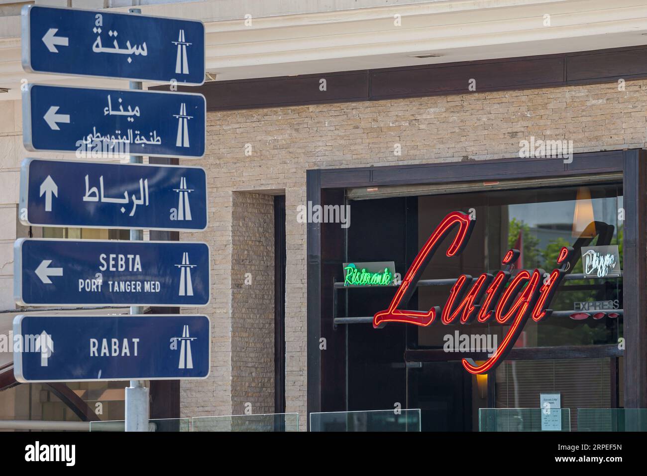 Morocco - Tangier - Road directions and italian restaurant sign Stock ...