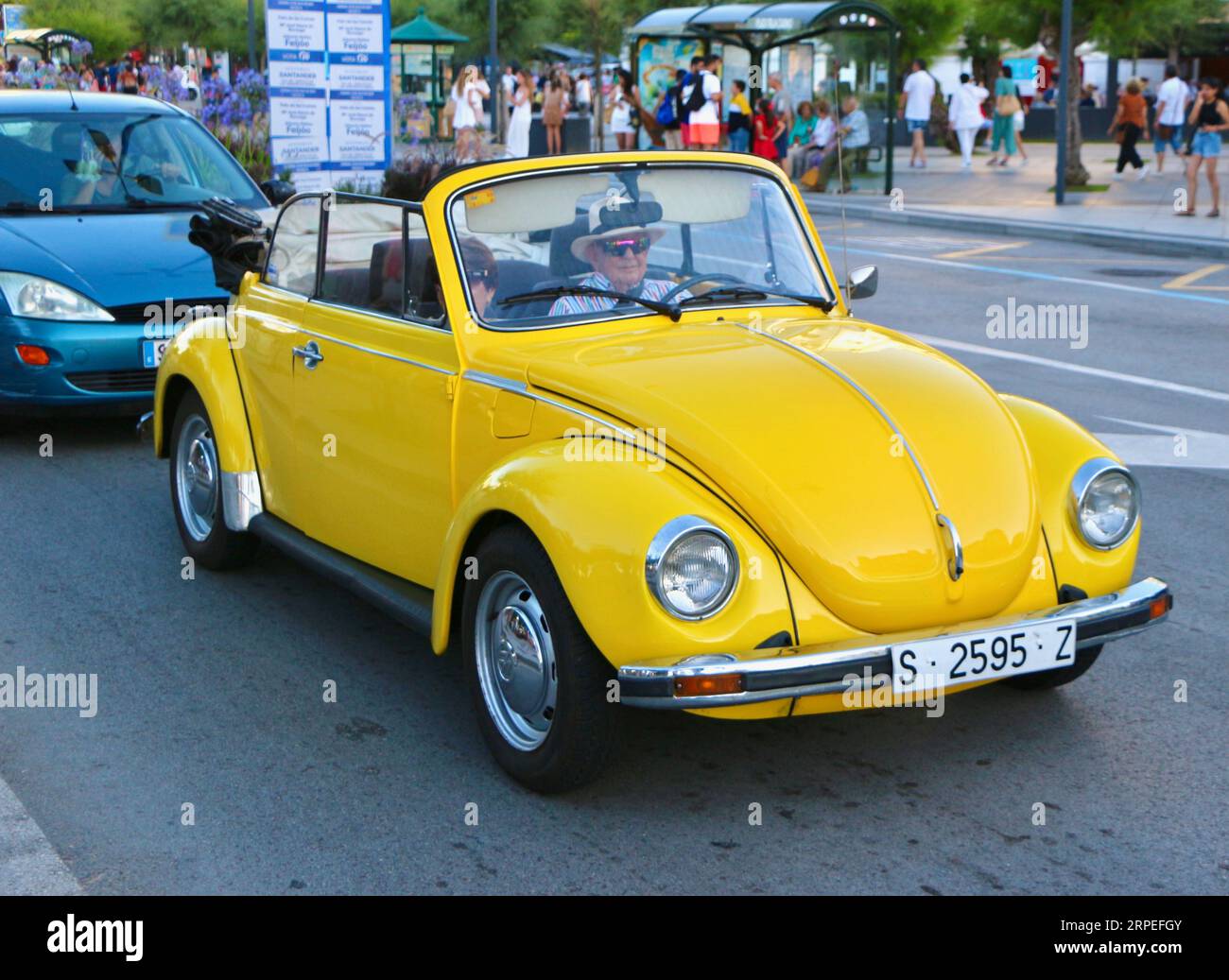 Yellow convertible classic Volkswagen Beetle 1303 car driving through ...